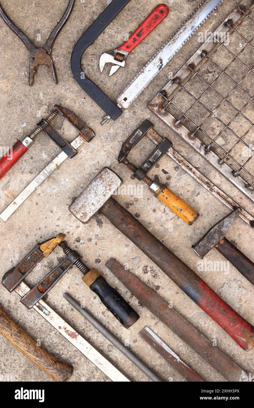 Old construction tools laid out on a concrete background, top view ...