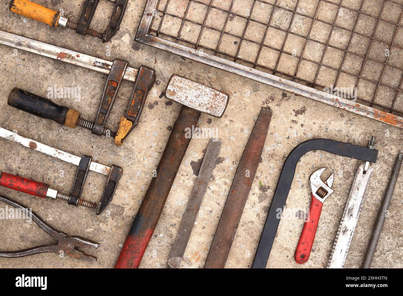 Old construction tools laid out on a concrete background, top view ...