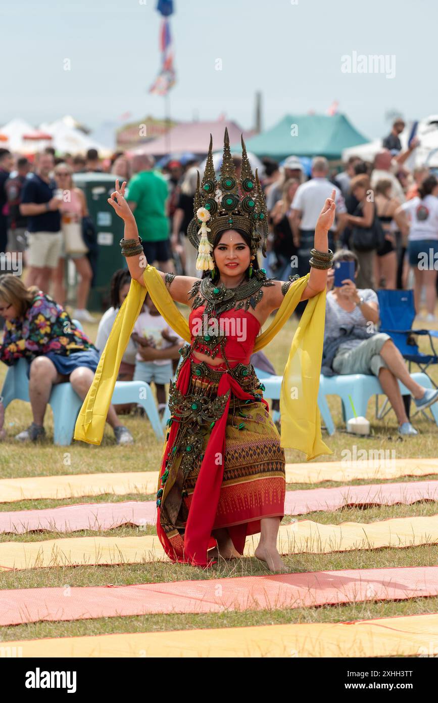 Lady dressed in traditional clothing performs a dance routine for ...