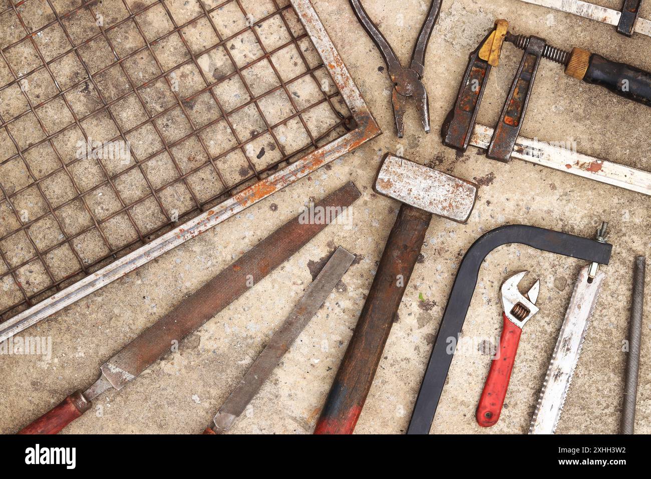 Old construction tools laid out on a concrete background, top view ...
