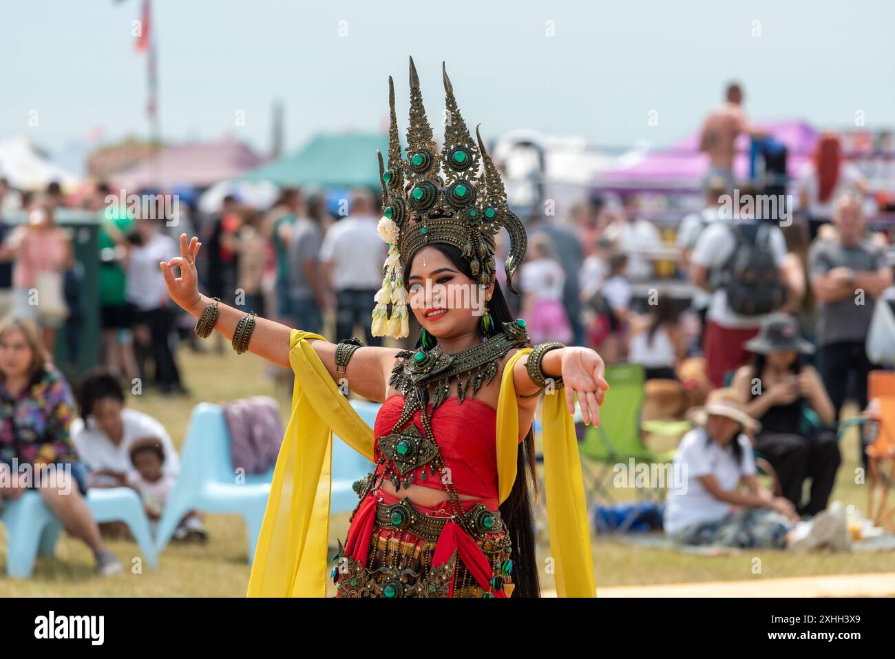 Lady dressed in traditional clothing performs a dance routine for ...
