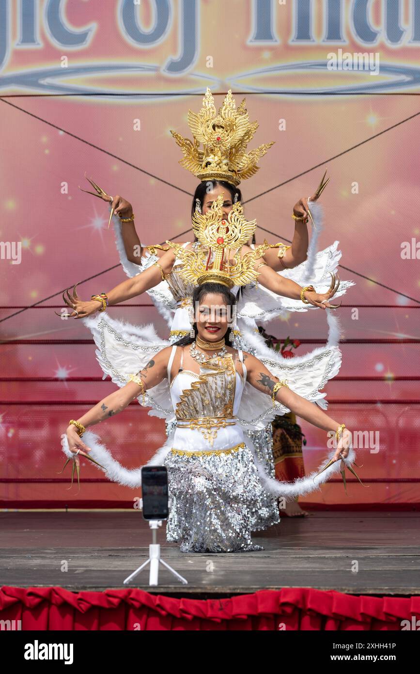 Ladies dressed in traditional clothing performs a dance routine on a ...