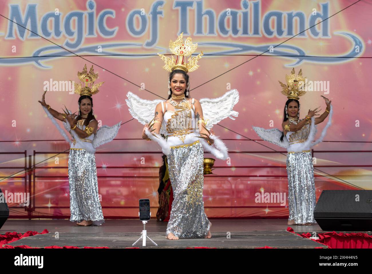 Ladies dressed in traditional clothing performs a dance routine on a ...