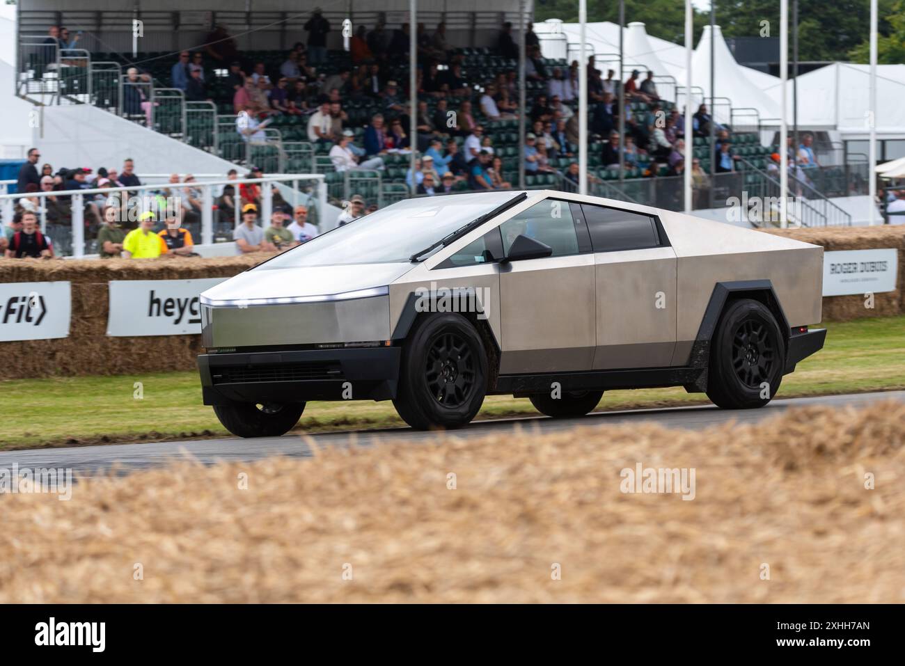 Tesla Cybertruck electric pickup truck driving up the hill climb track ...