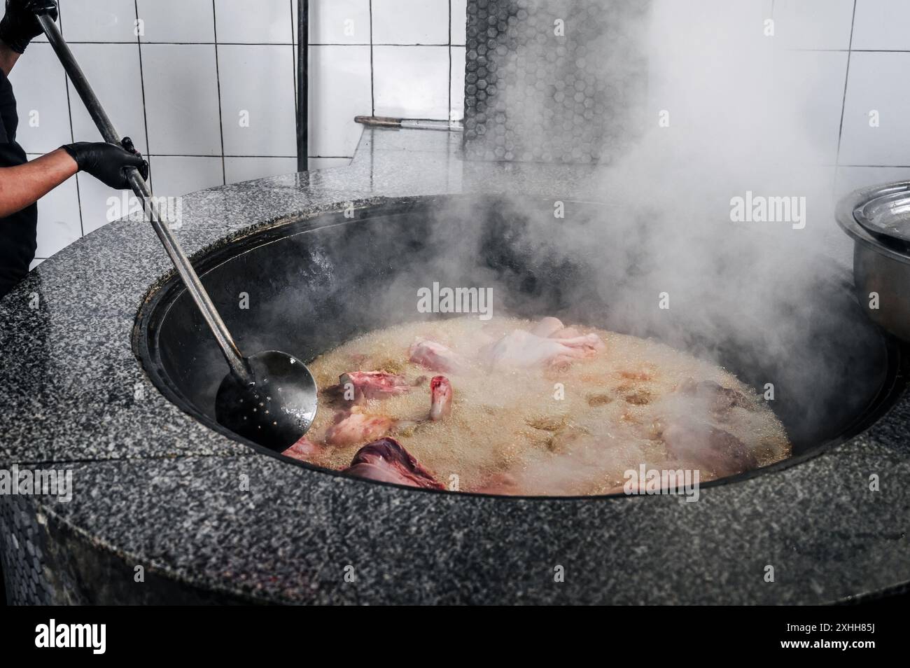 Male cook stirs hot pilaf hi-res stock photography and images - Alamy