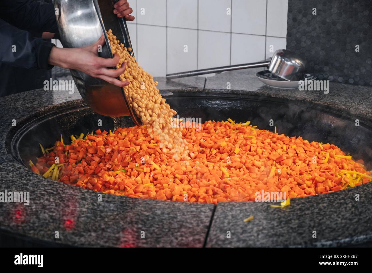 Male cook pours chickpeas hi-res stock photography and images - Alamy
