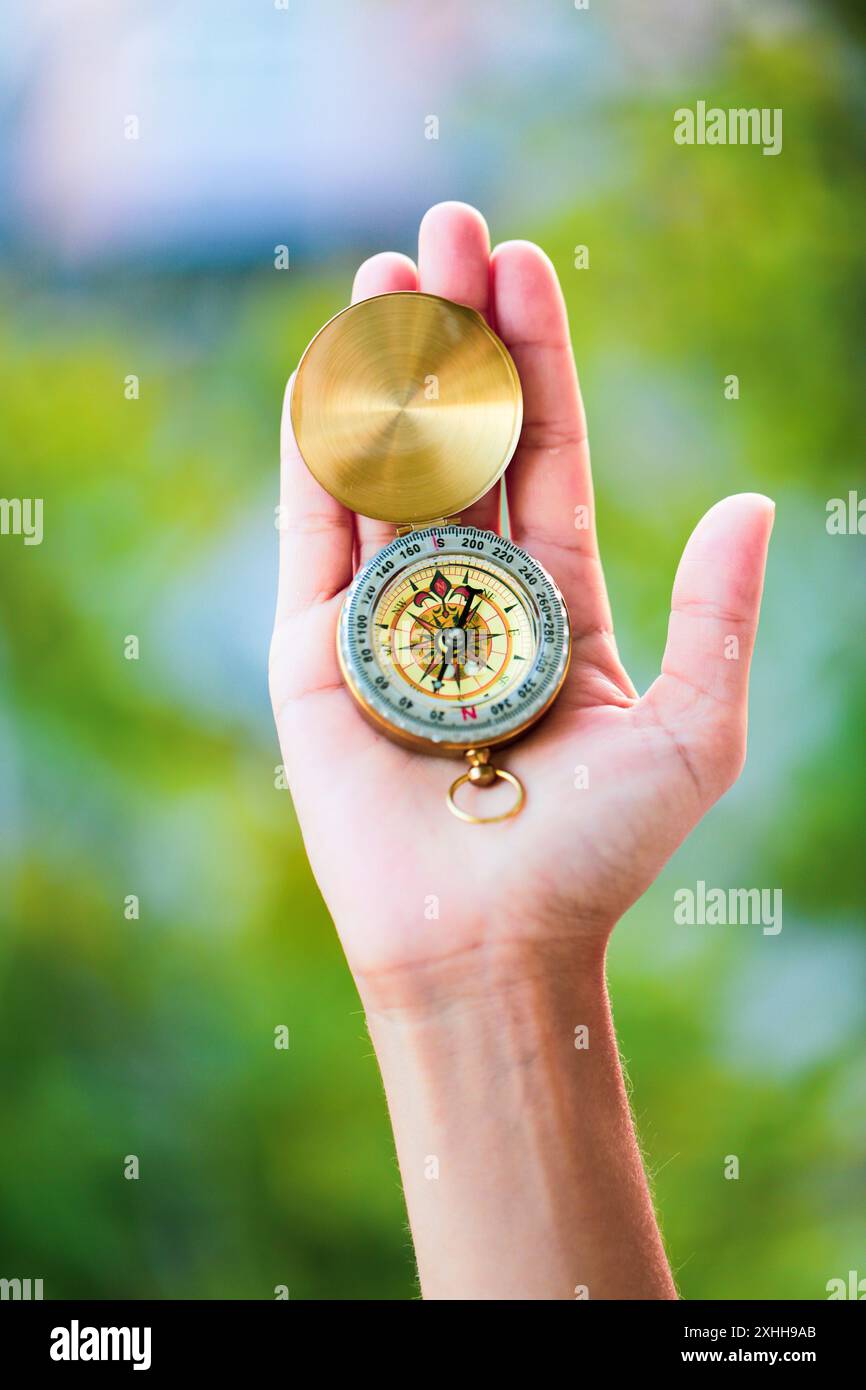 hand holding a compass in nature Stock Photo - Alamy