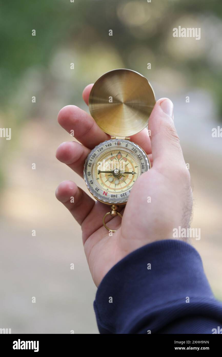 hand holding a compass in nature Stock Photo - Alamy