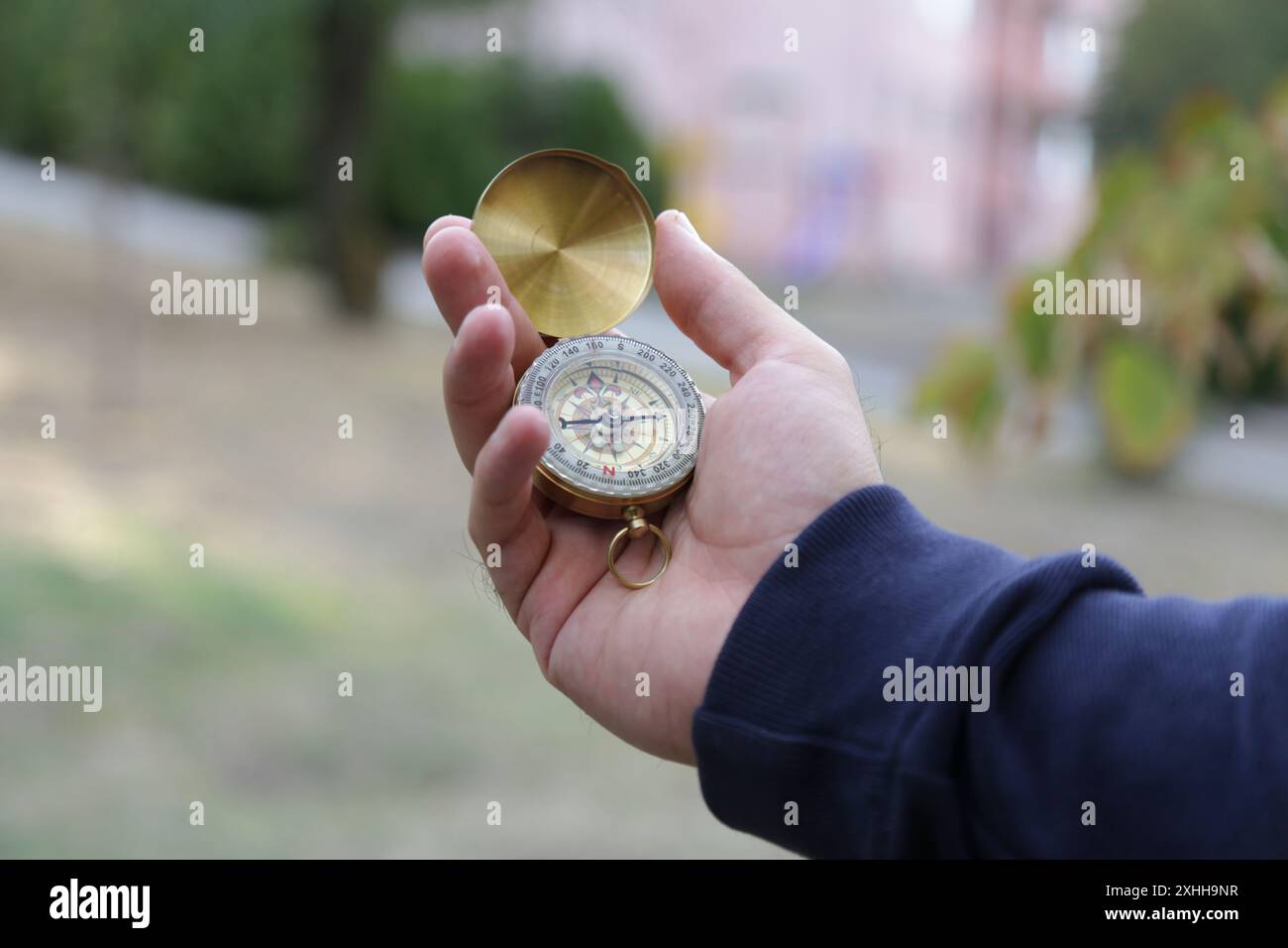 hand holding a compass in nature Stock Photo - Alamy