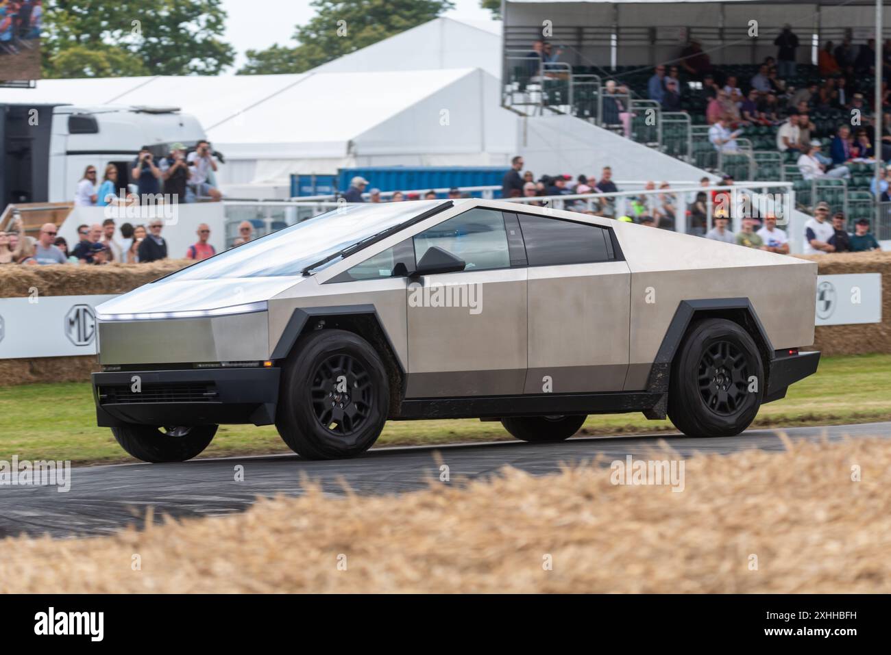 Tesla Cybertruck electric pickup truck driving up the hill climb track ...