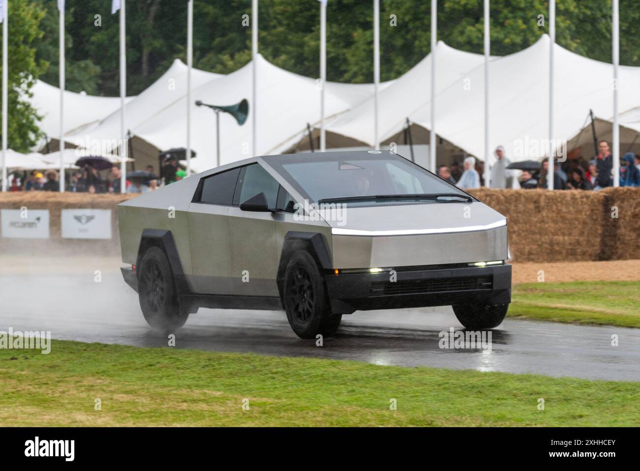 Tesla Cybertruck electric pickup truck driving up the hill climb track ...