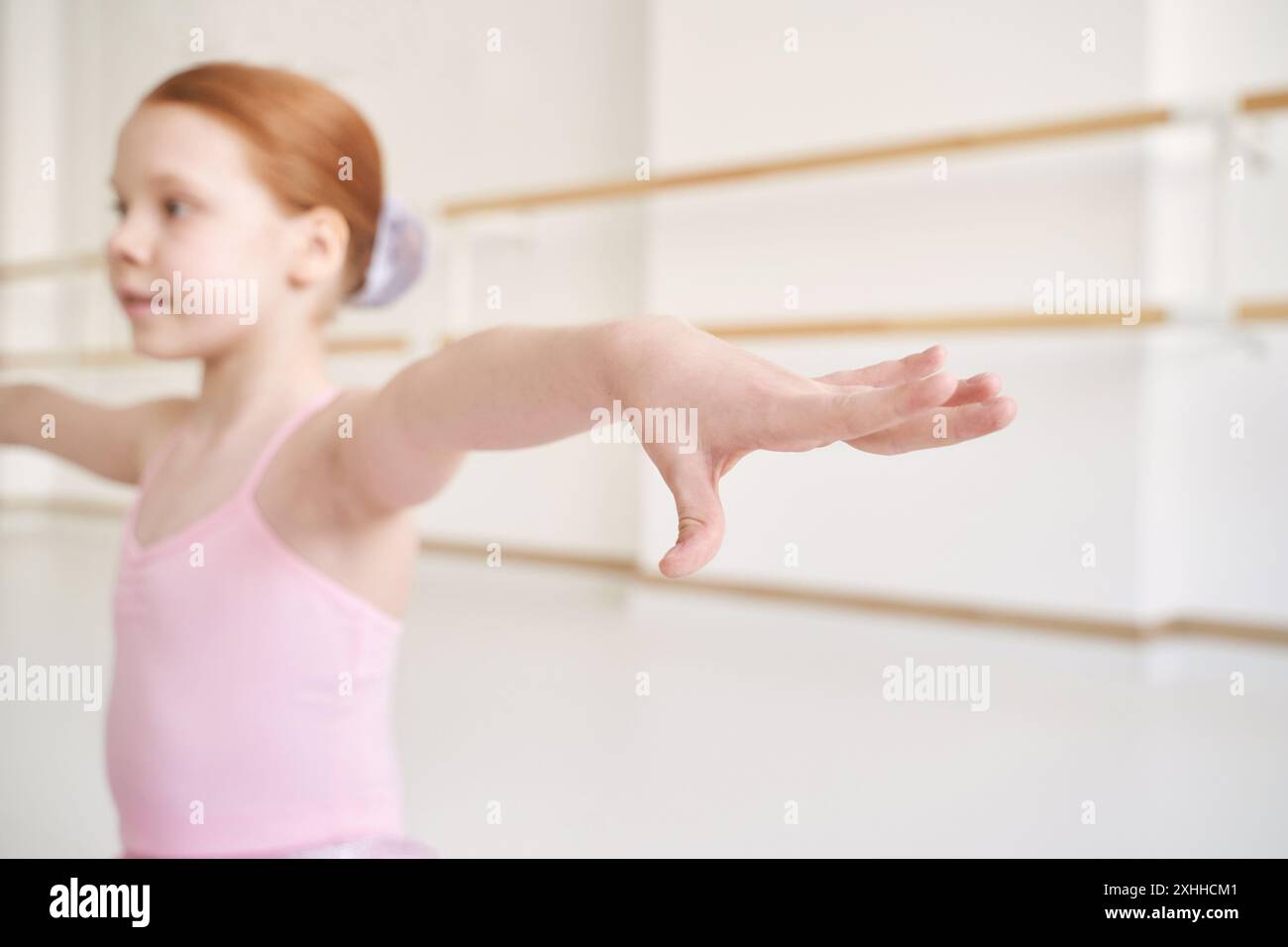 Young ballet girl at studio lesson. Training performance. Stretching ...