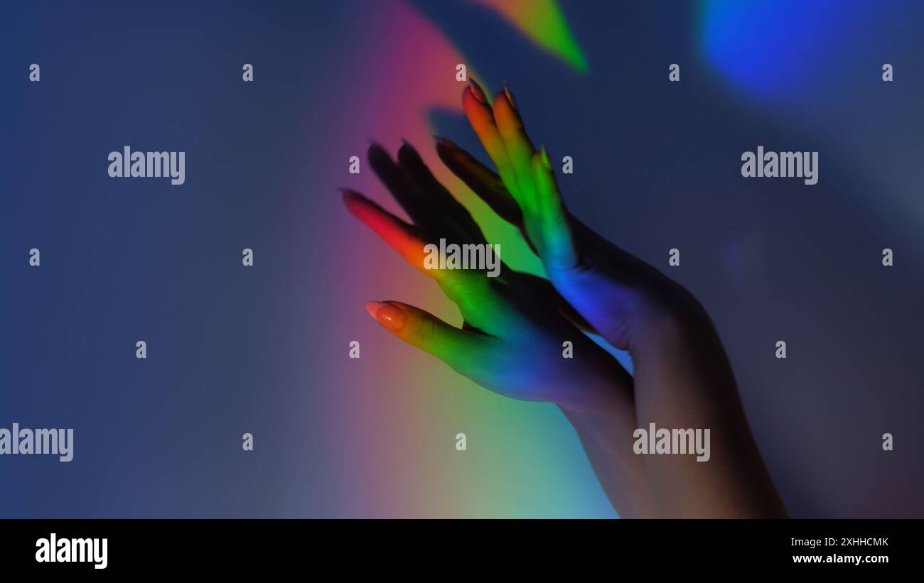 Rainbow hands. Prism light. Diversity harmony. LGBT rights. Female arms ...