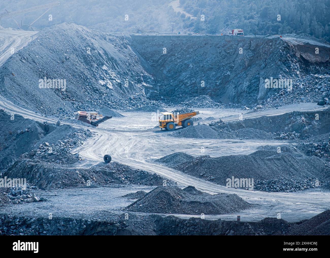 Industrial diabase quarry with heavy machinery and dump trucks in ...