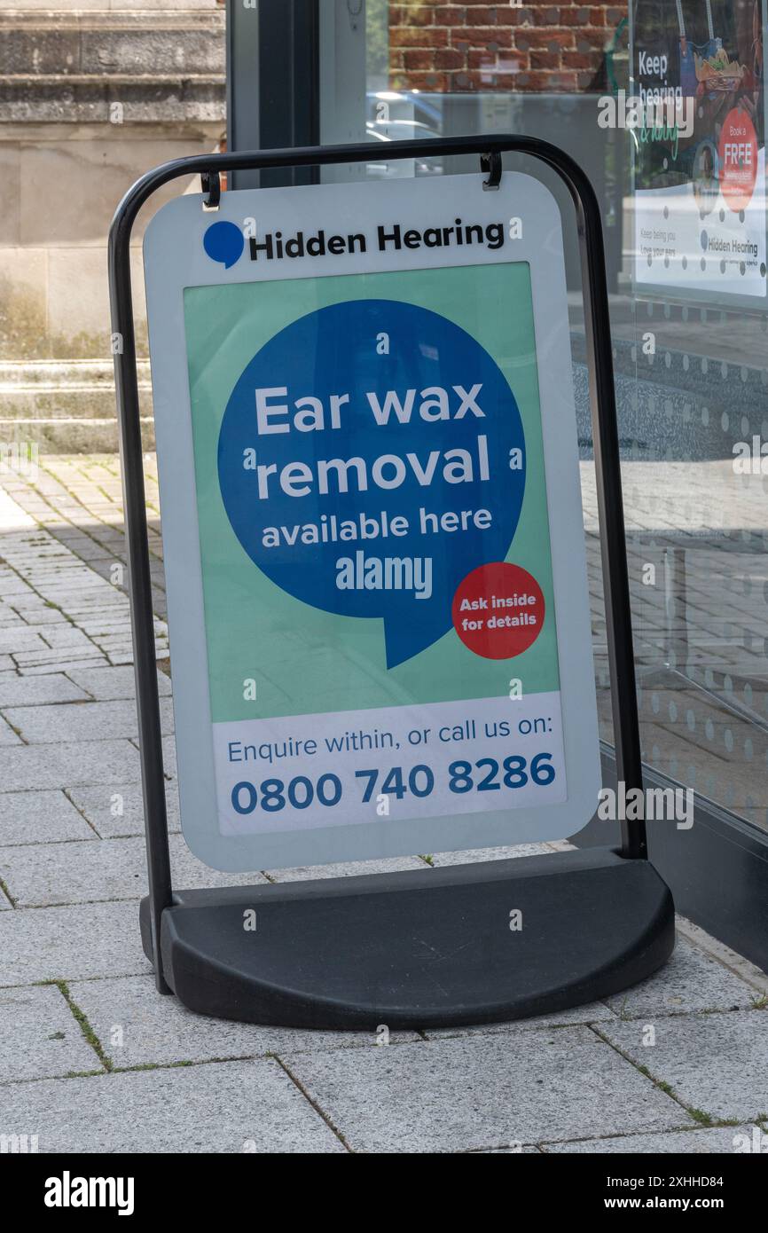 Sign outside Hidden Hearing advertising Ear wax removal available here ...