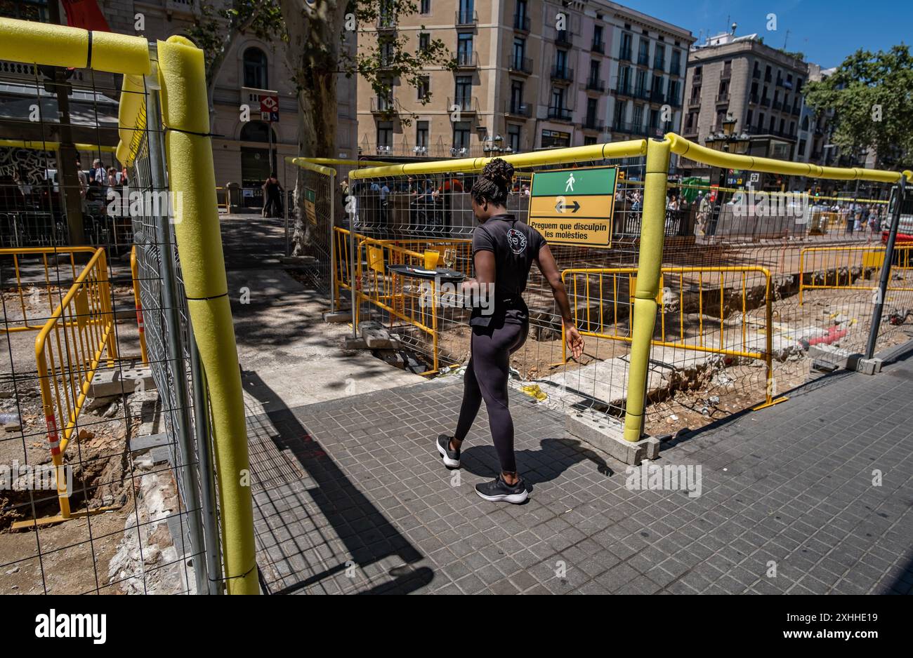 A waitress at a bar and restaurant establishment is seen serving tables ...