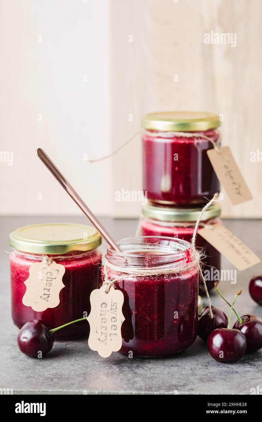 Homemade cherry jam in small jars and fresh cherries Stock Photo - Alamy