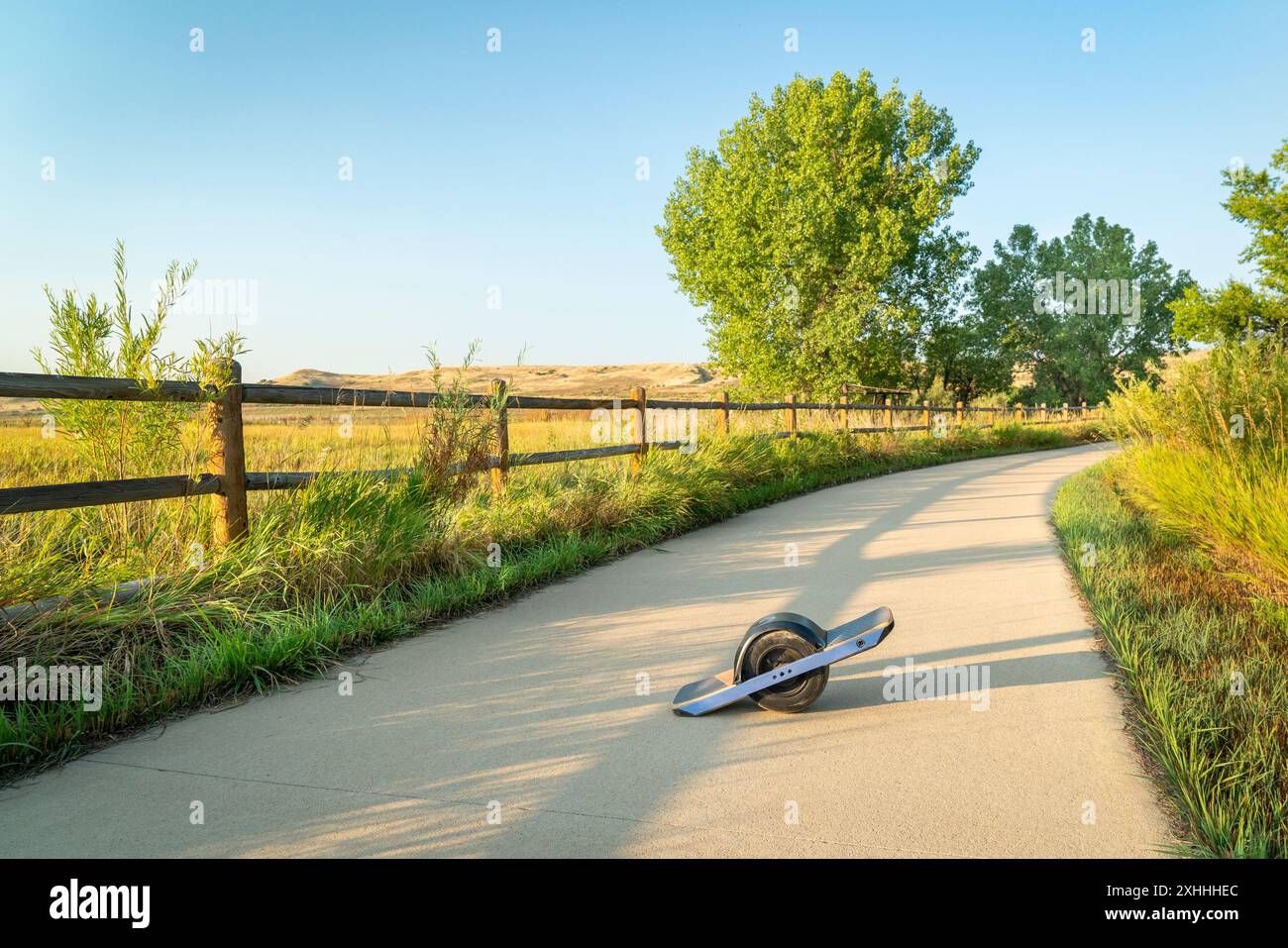 One-wheeled electric skateboard in the late summer morning on the ...