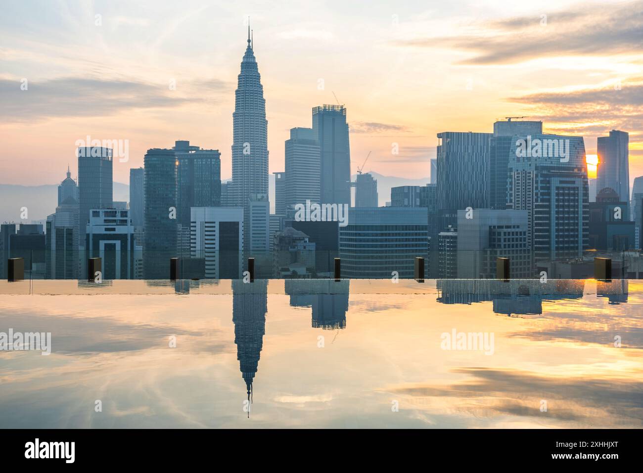 Kuala Lumpur city skyline with reflections of high-rise buildings and ...