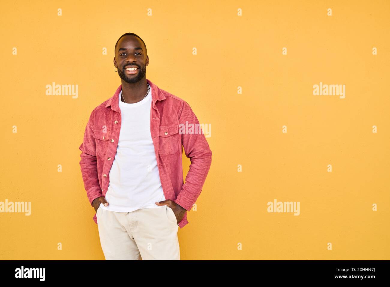 Happy cool gen z African hipster man looking at camera standing at ...