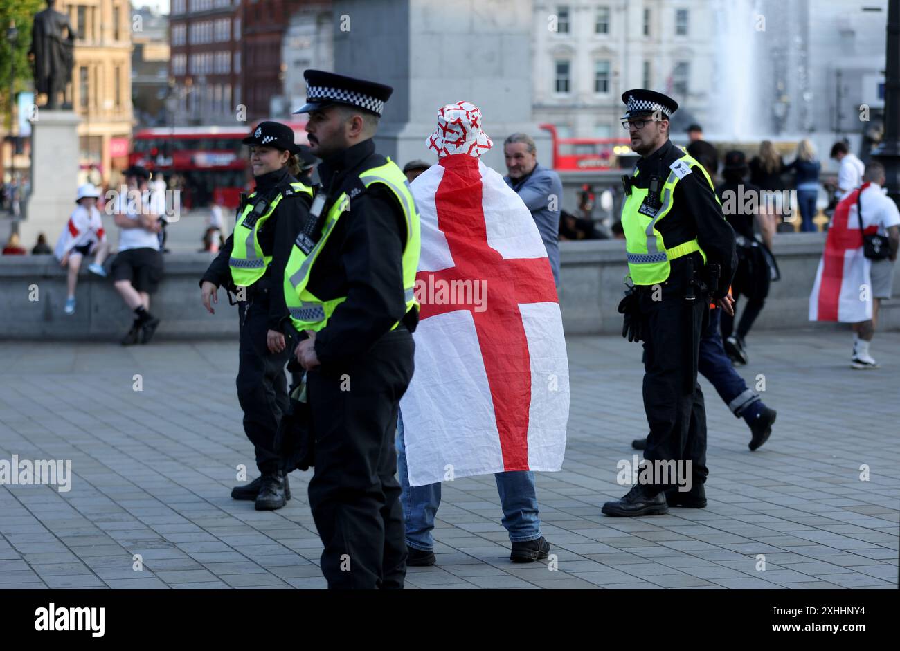 An England fan speaking to police officers in Trafalgar Square, London ...