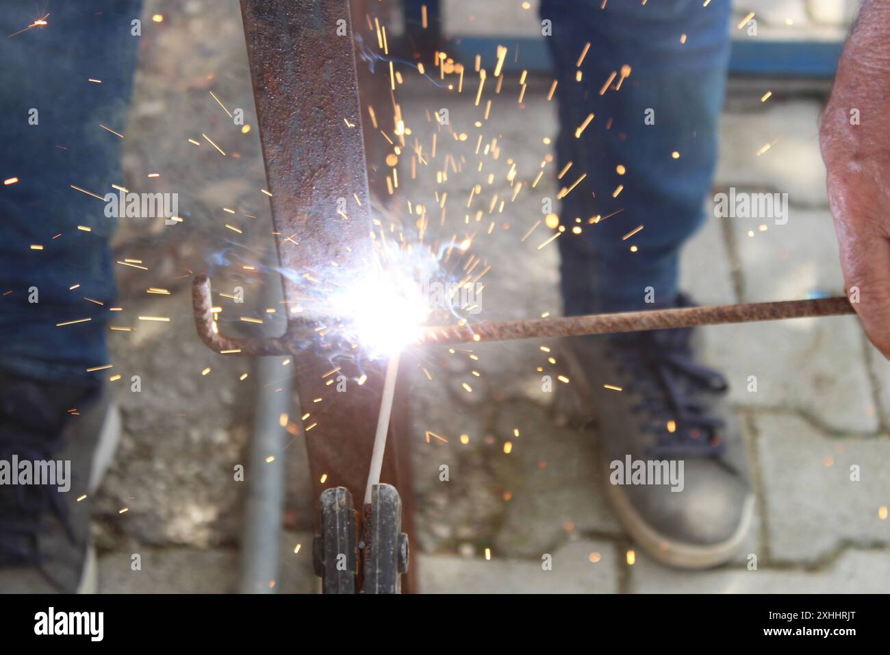 Welding man working on iron welding in construction site. Close up ...