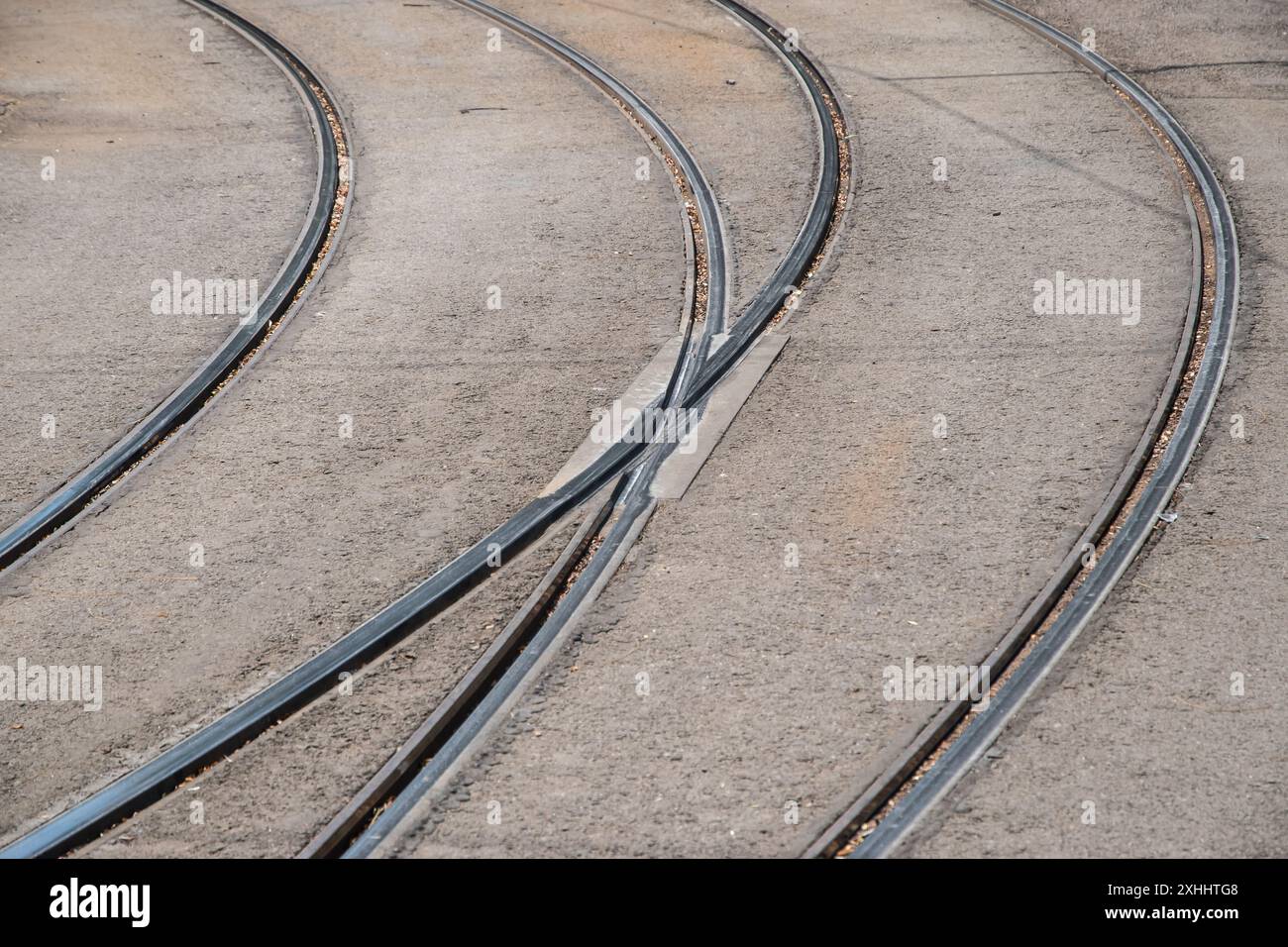 Intersecting tram lines on a curve closeup Stock Photo - Alamy