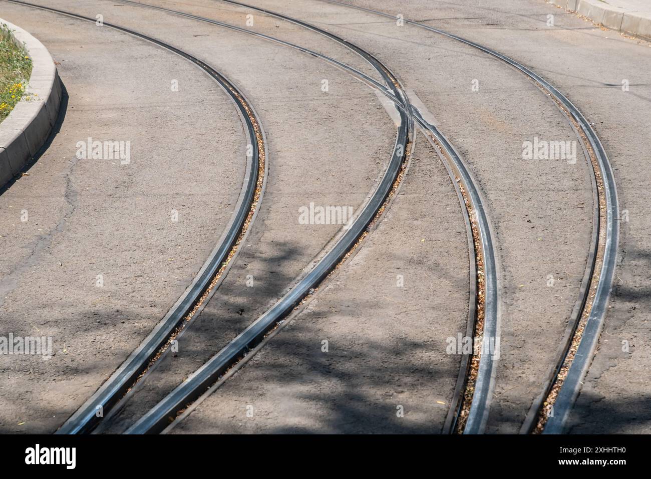 Intersecting tram lines on a curve closeup Stock Photo - Alamy