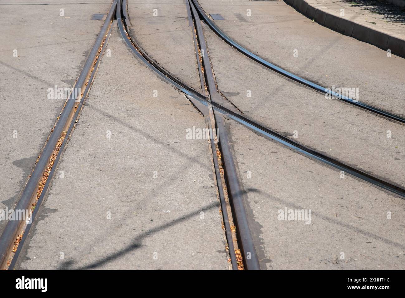 Intersecting tram lines on a curve closeup Stock Photo - Alamy