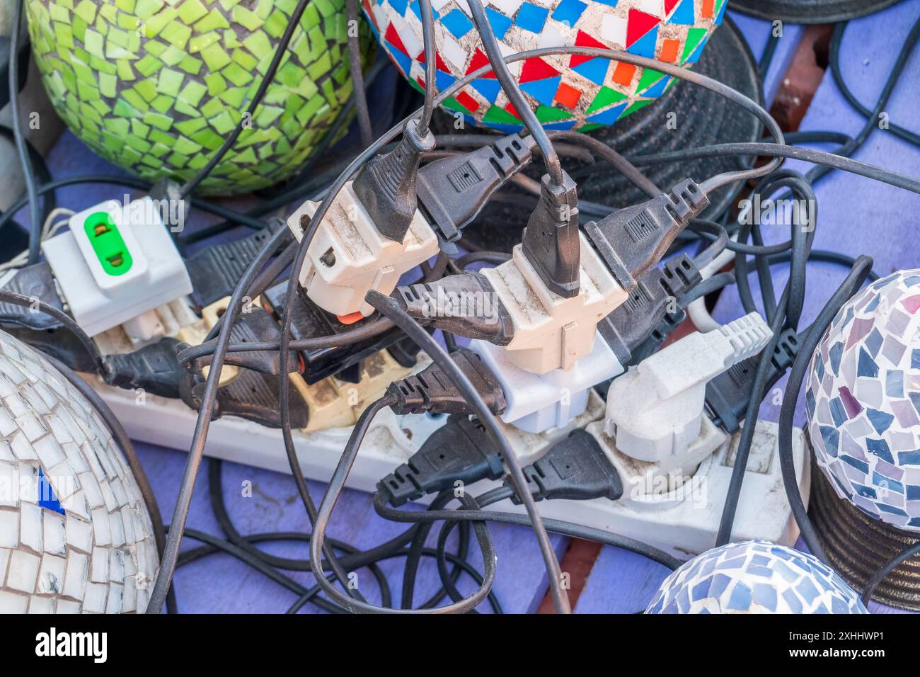 Old and damaged electric adapter power plug has many appliances are ...