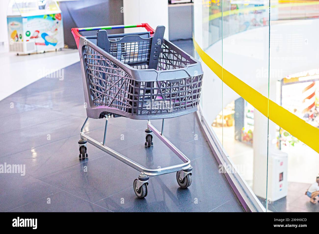 empty plastic cart in the interior of a shopping center. family ...