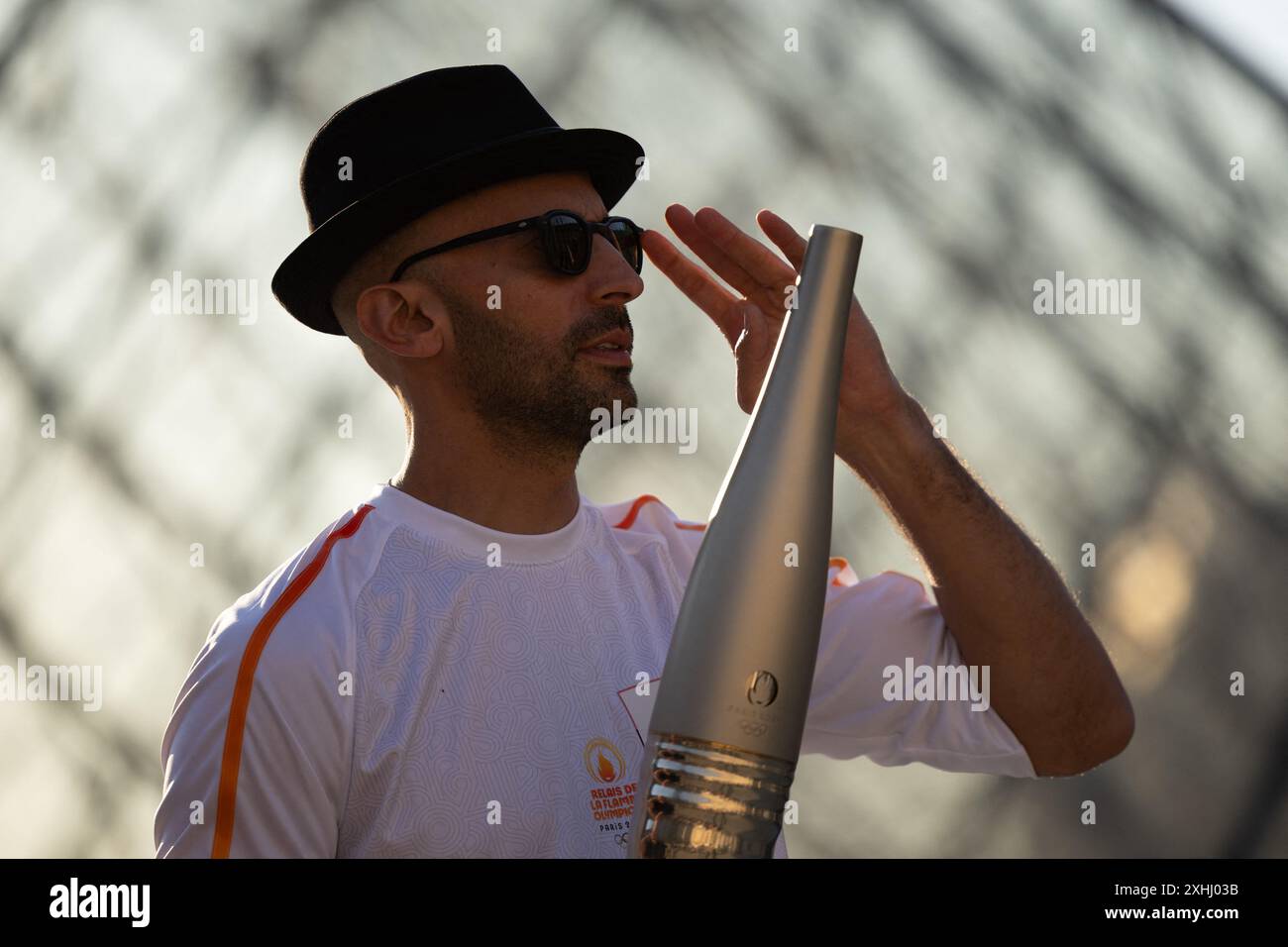 French photographer and street artist JR hold the torches during the ...