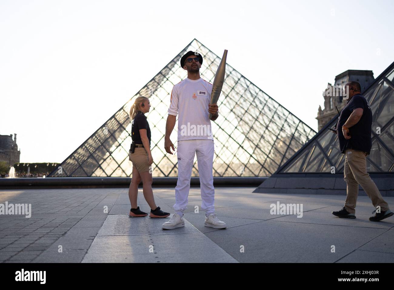 French photographer and street artist JR hold the torches during the ...