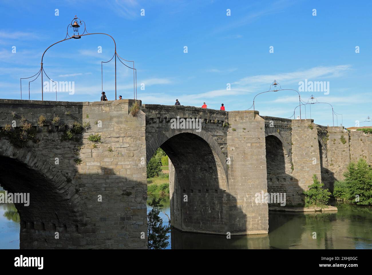 Pedestrians crossing the famous medieval bridge over the Aude River in ...