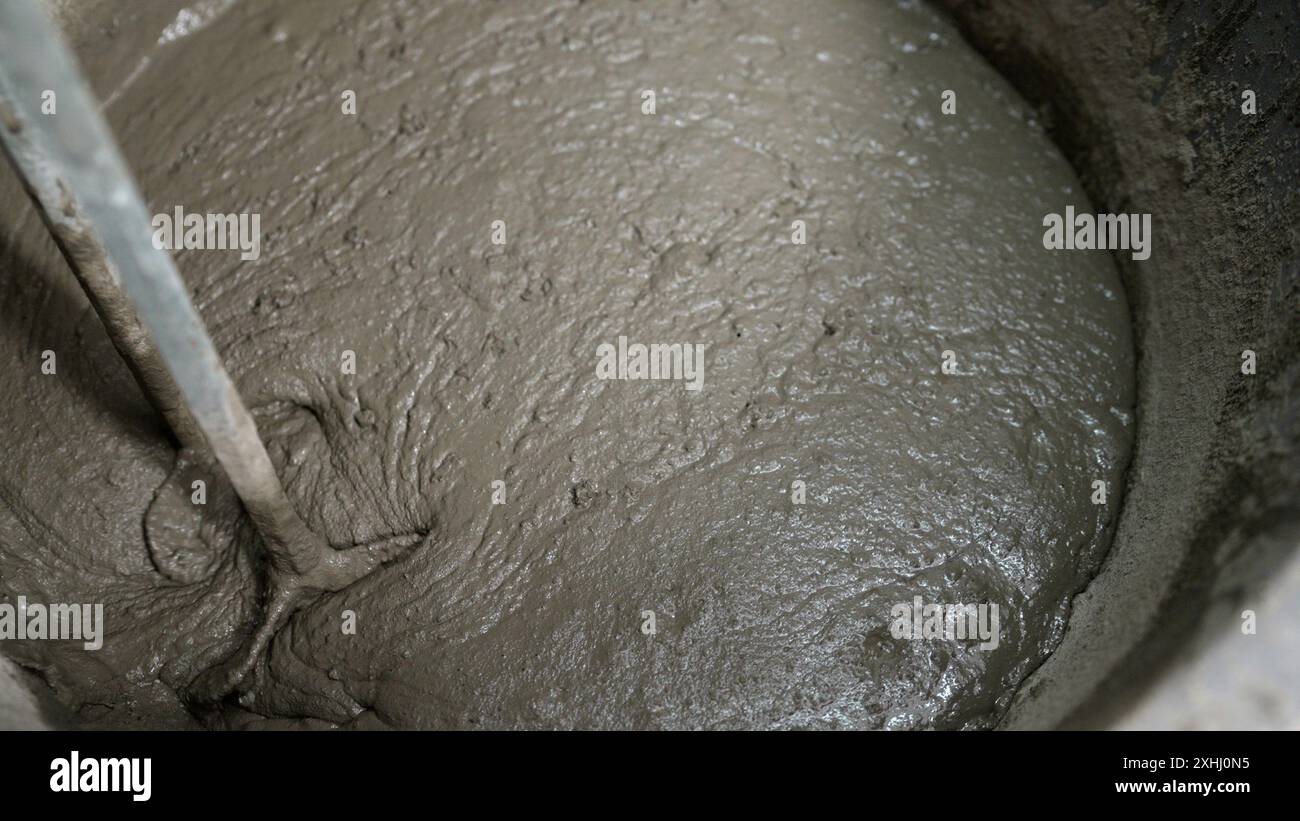Construction worker mixes wet grey hi-res stock photography and images ...
