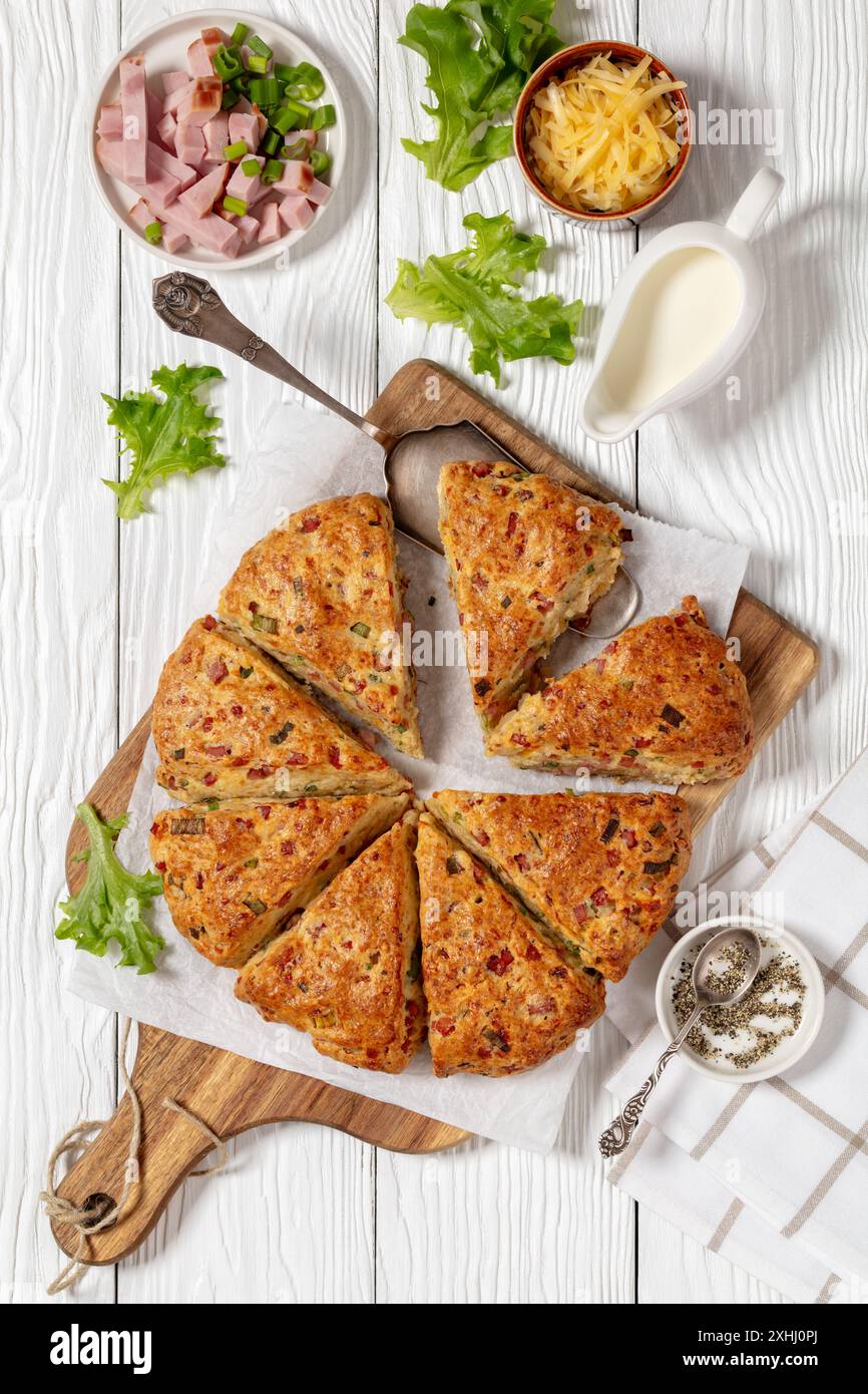 Ham and cheese triangle scones on cutting board with ingredients on ...