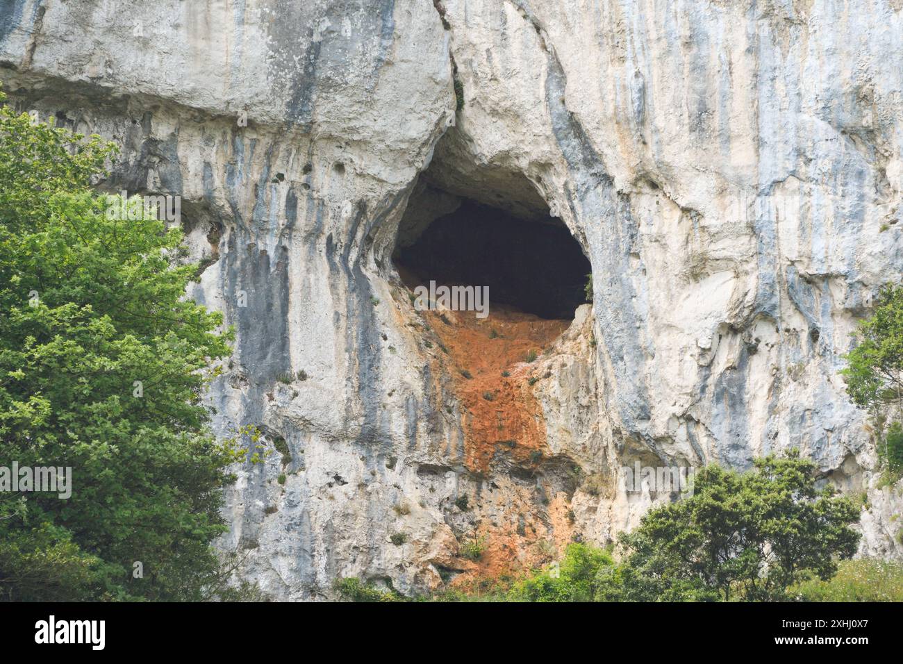 Exit from an underground grotto caused by water in a limestone wall ...