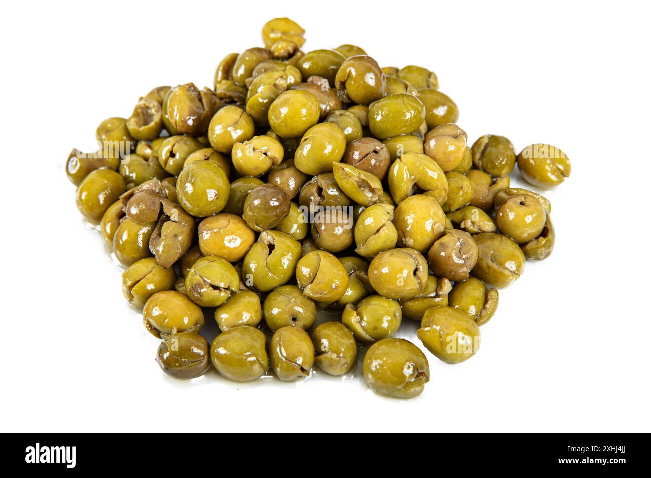Homemade crushing olive making. Fresh green olives are breaking one by ...