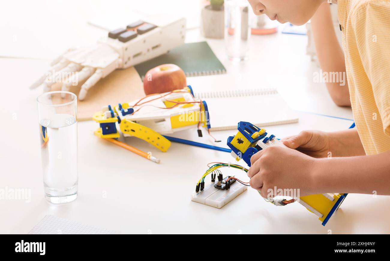 Young Student Building a Robotic Hand at a Desk, Cropped Stock Photo ...