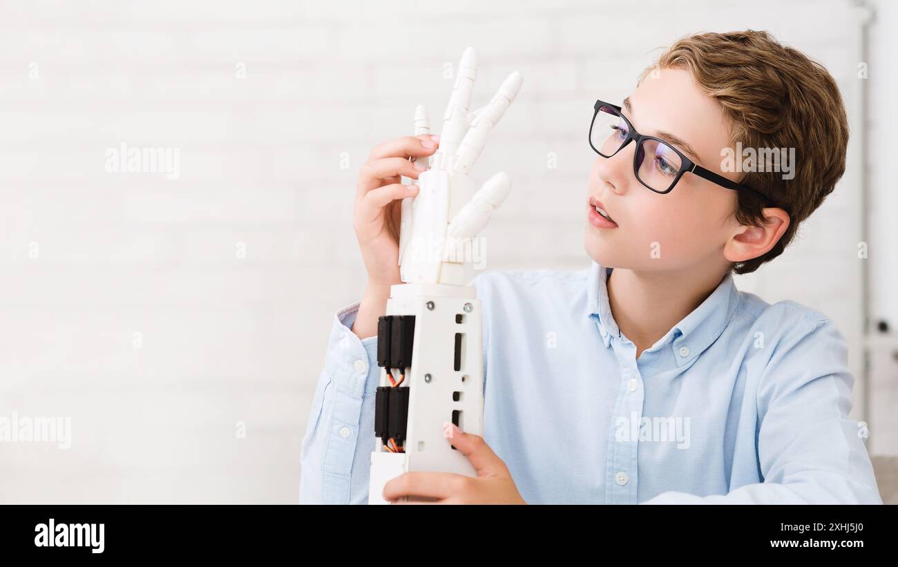 Young Boy Examining a Robotic Hand in a Classroom Setting Stock Photo ...