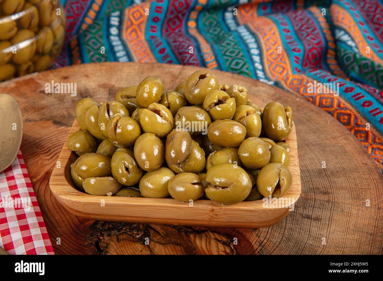 Homemade crushing olive making. Fresh green olives are breaking one by ...
