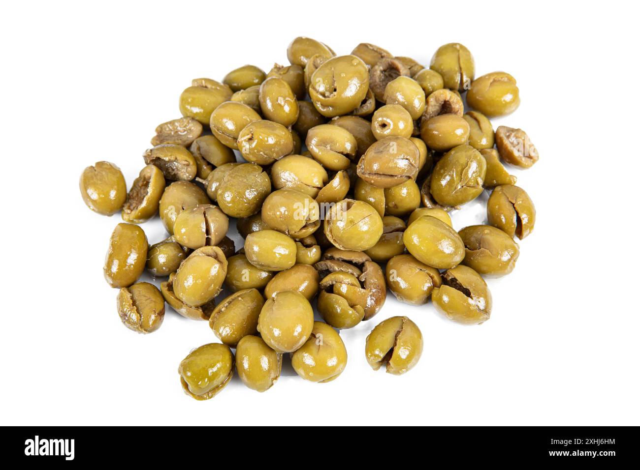 Homemade crushing olive making. Fresh green olives are breaking one by ...