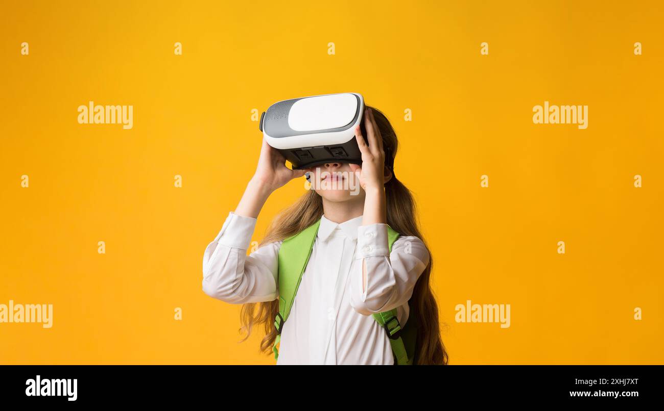 Little Schoolgirl Experiencing Virtual Reality On Yellow Studio ...