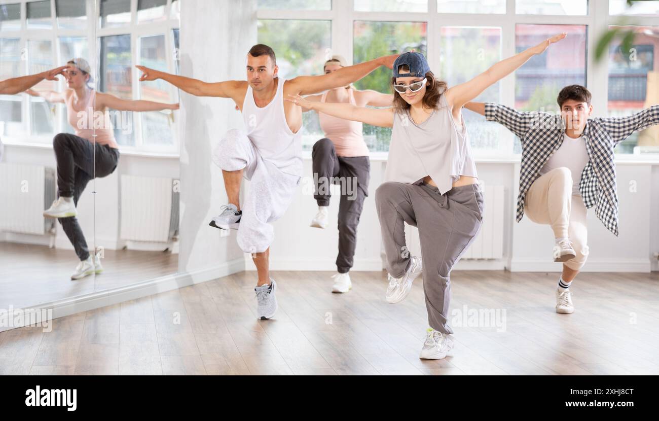 Young girl practicing hip hop reject step in training hall Stock Photo ...