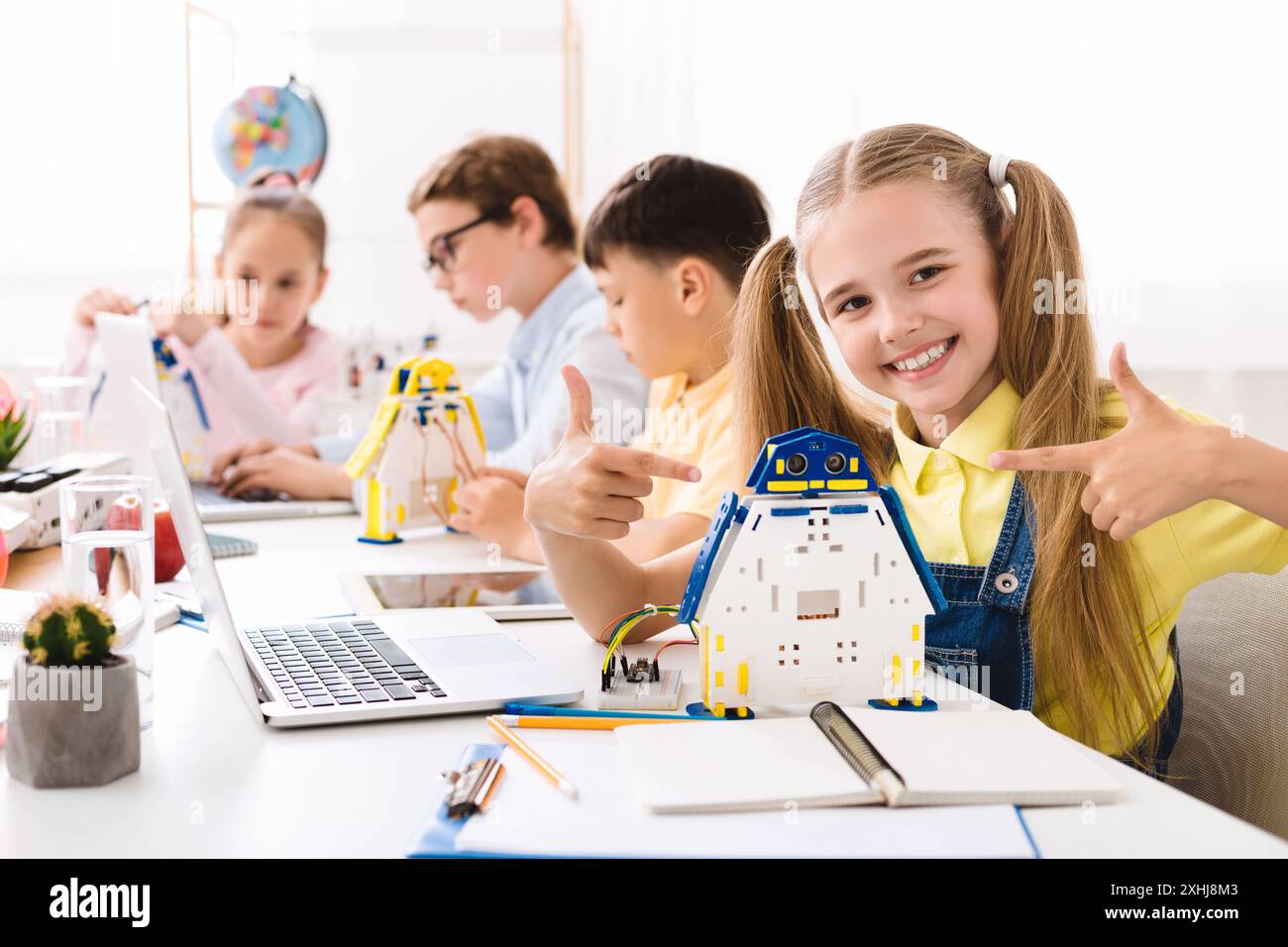 Smiling Girl Points to Her Robot Creation in STEM Classroom Stock Photo ...