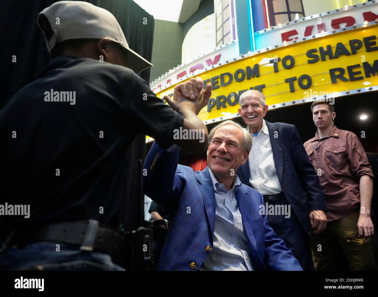 A kid, left, high-fives Gov. Greg Abbott after a press conference on ...