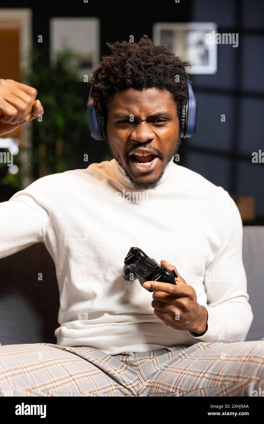 Gamer feeling relieved after winning videogame level, screaming at ...