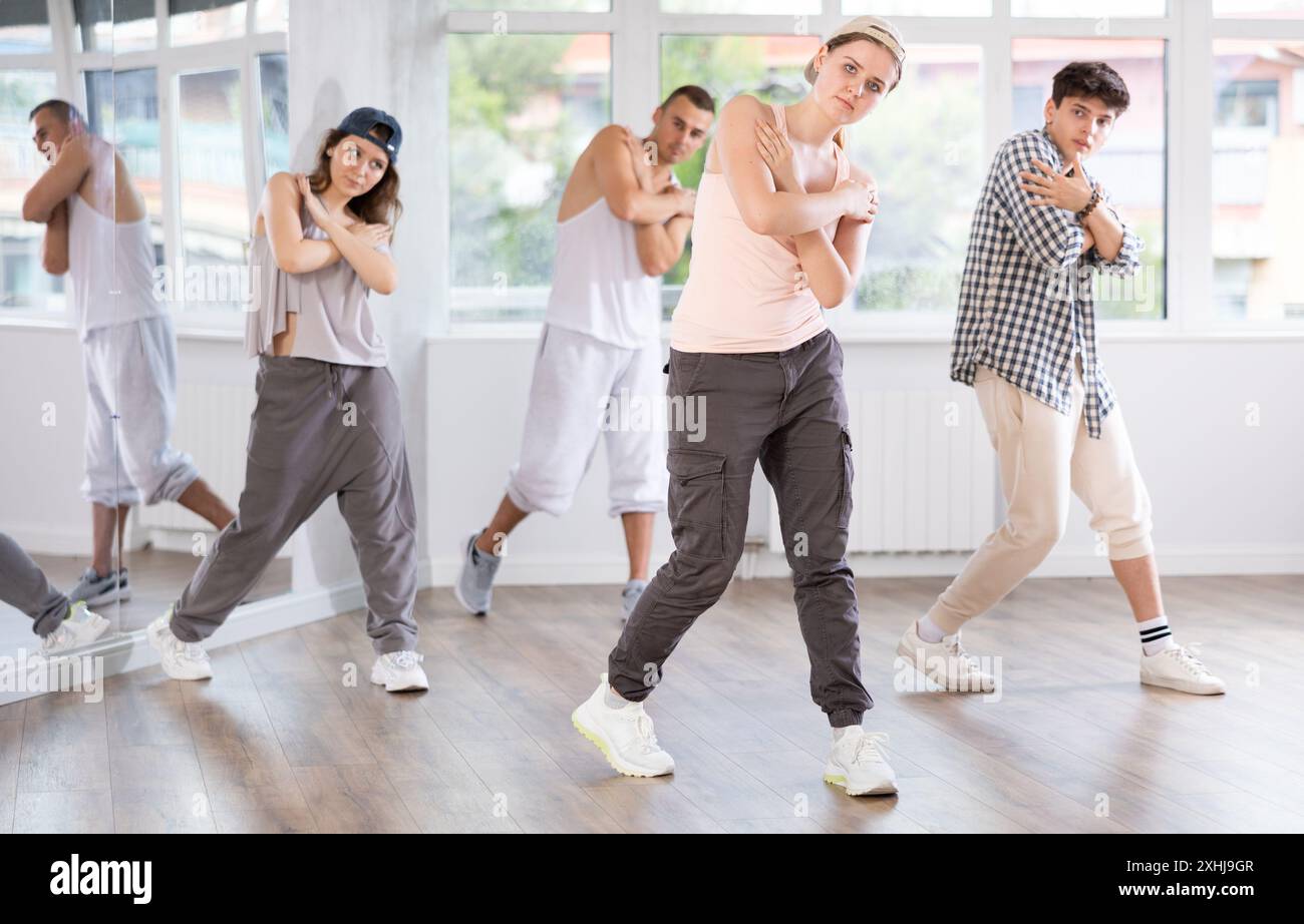 Group of young people perform choreographic exercises and teaches ...