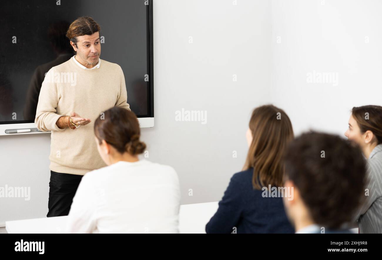 Male trainer near interactive board conducting advanced training ...