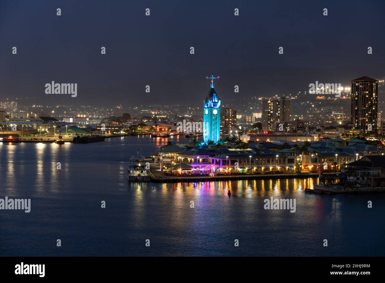 The port facility and Hawaii Pacific University illuminated at night in ...